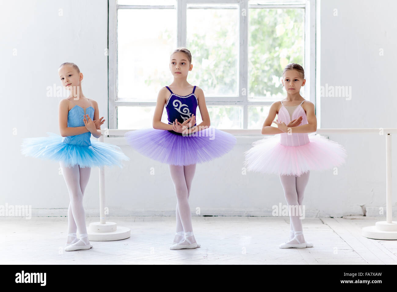 Three little ballet girls in tutu and posing together Stock Photo - Alamy