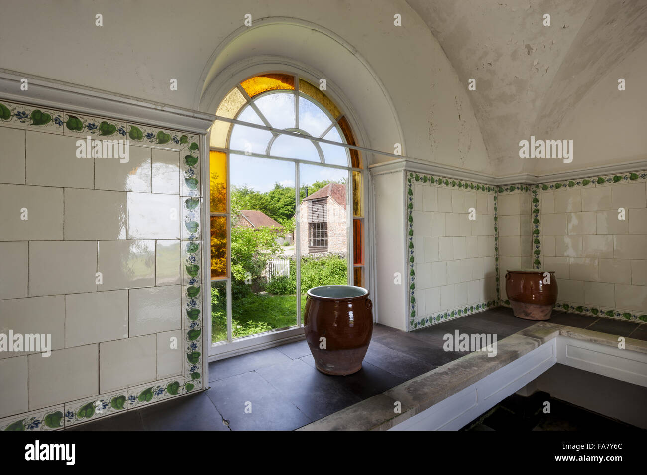 The dairy showing the tiled wall and window with pots in the foreground ...