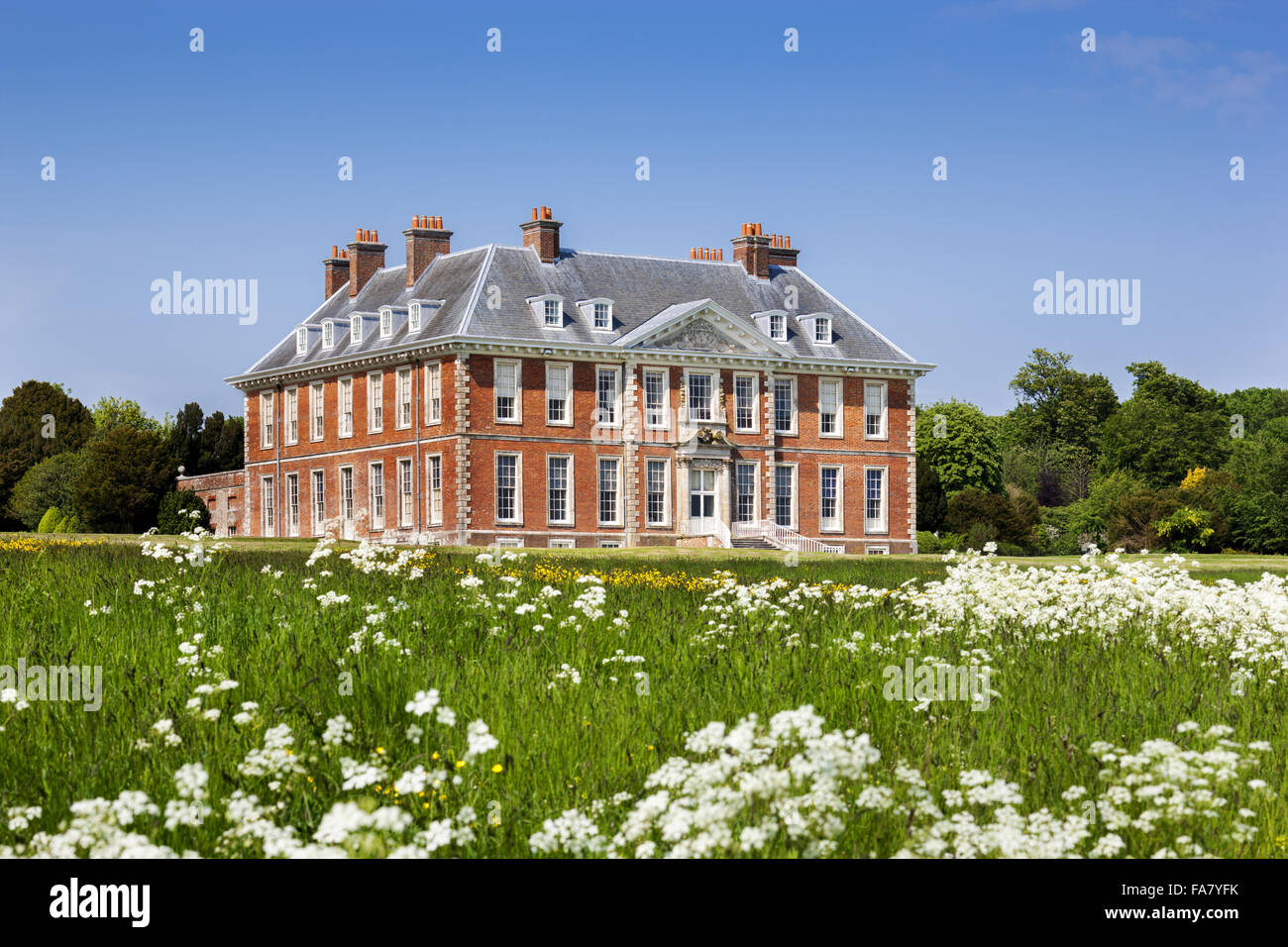 South front of the house from the meadow with white flowers at Uppark ...