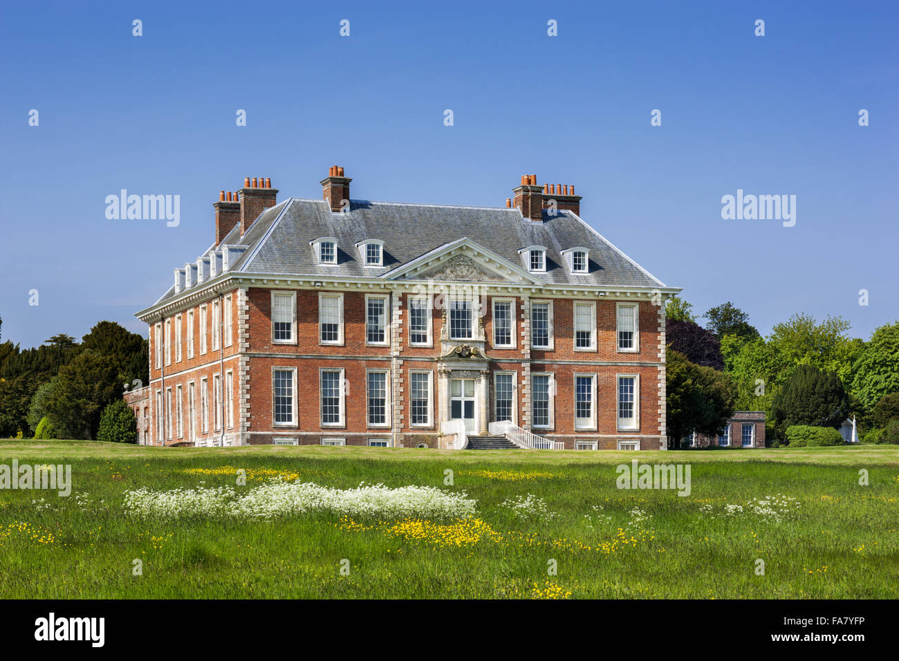 South front of the house from the meadow with white flowers at Uppark ...