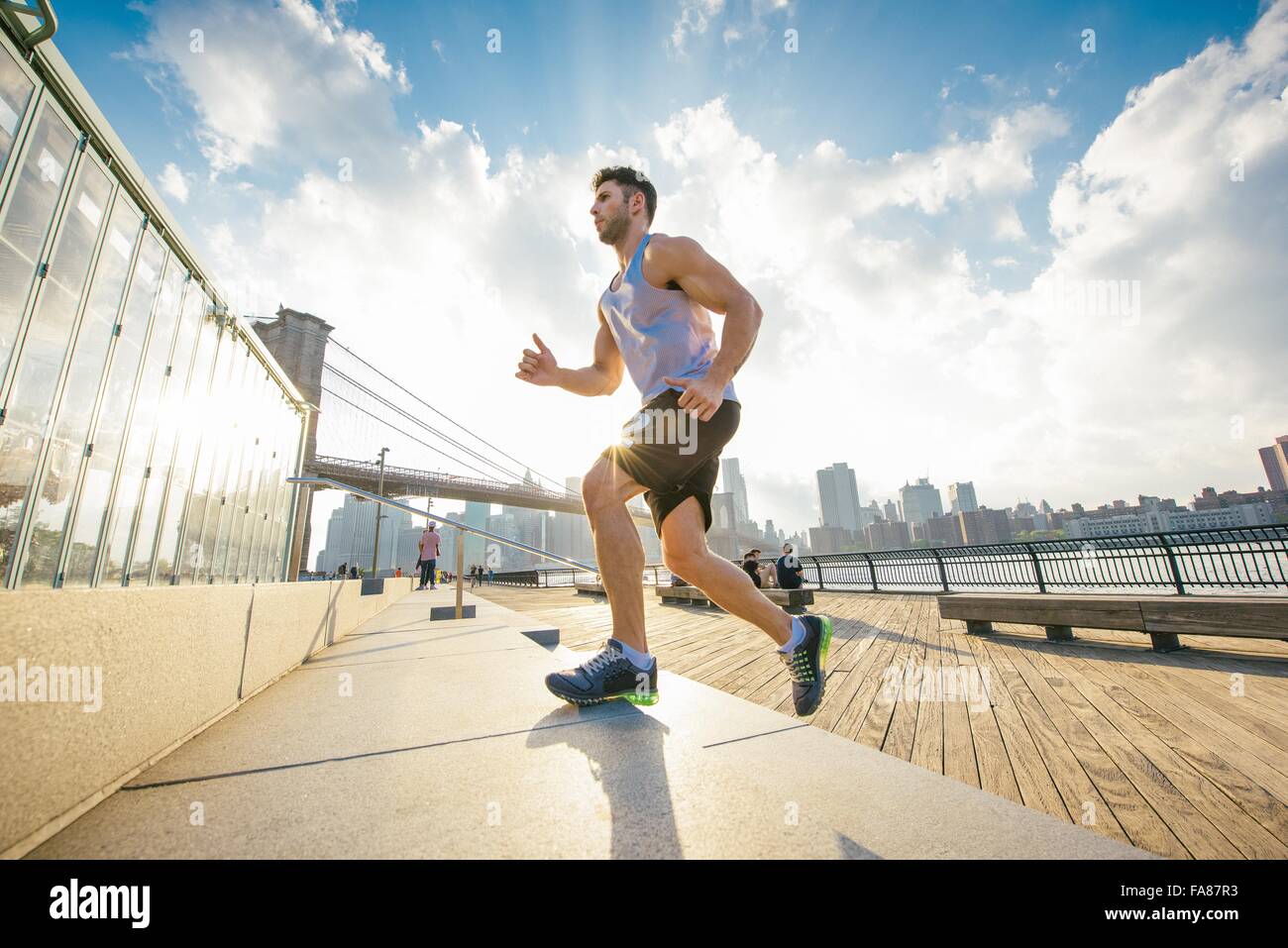 Young man running at riverside hi-res stock photography and images - Alamy