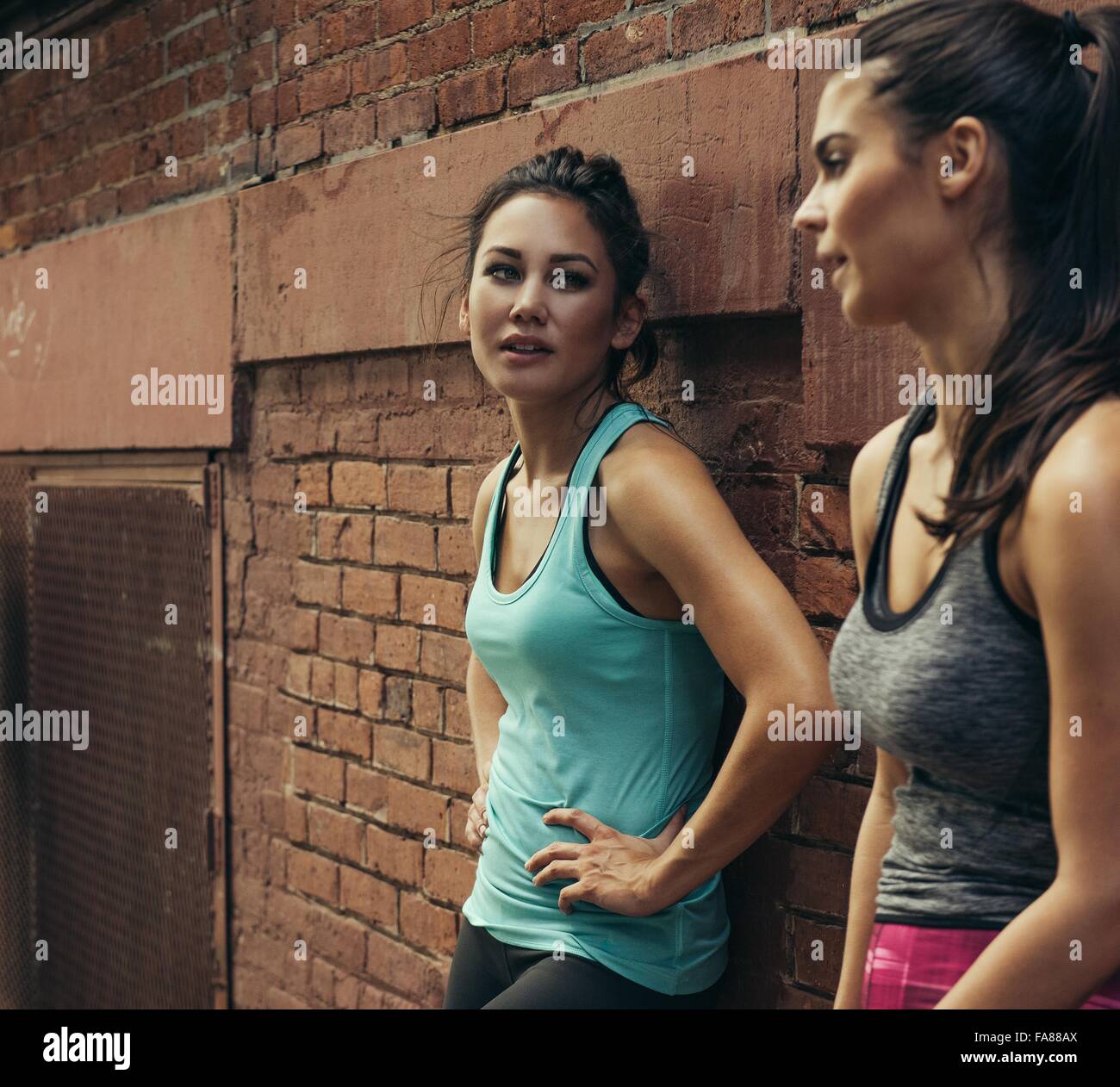 Young women taking a break from running Stock Photo - Alamy