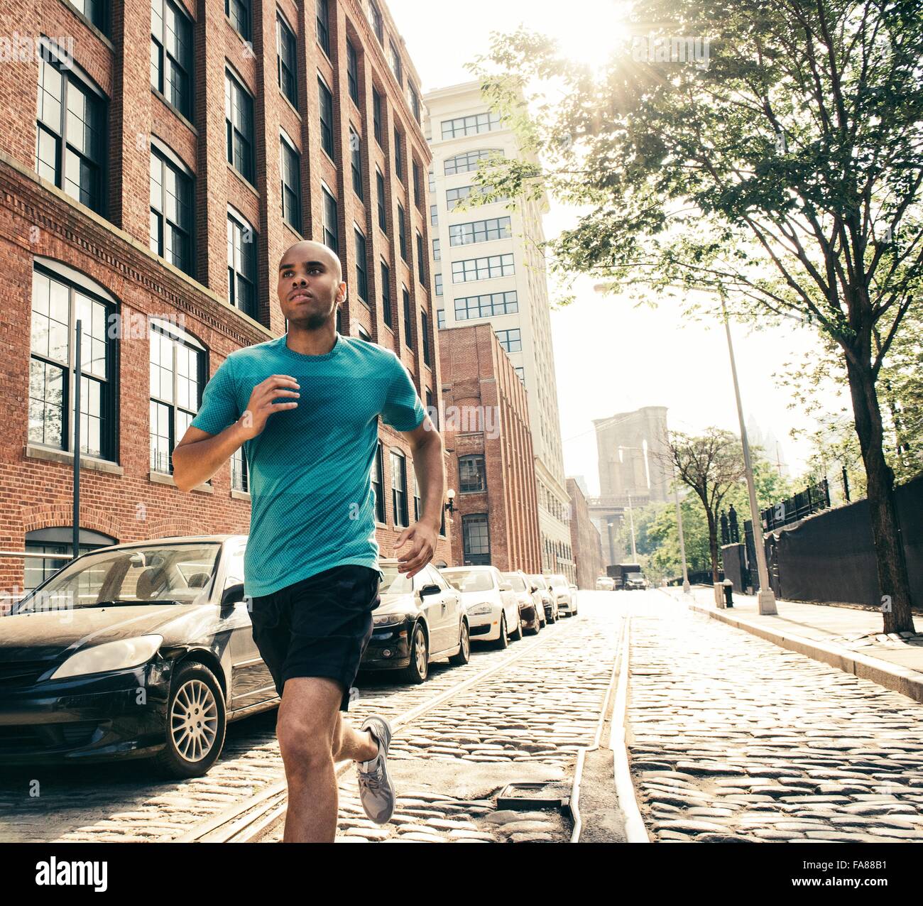 Young man running in Dumbo, Brooklyn, New York, USA Stock Photo - Alamy