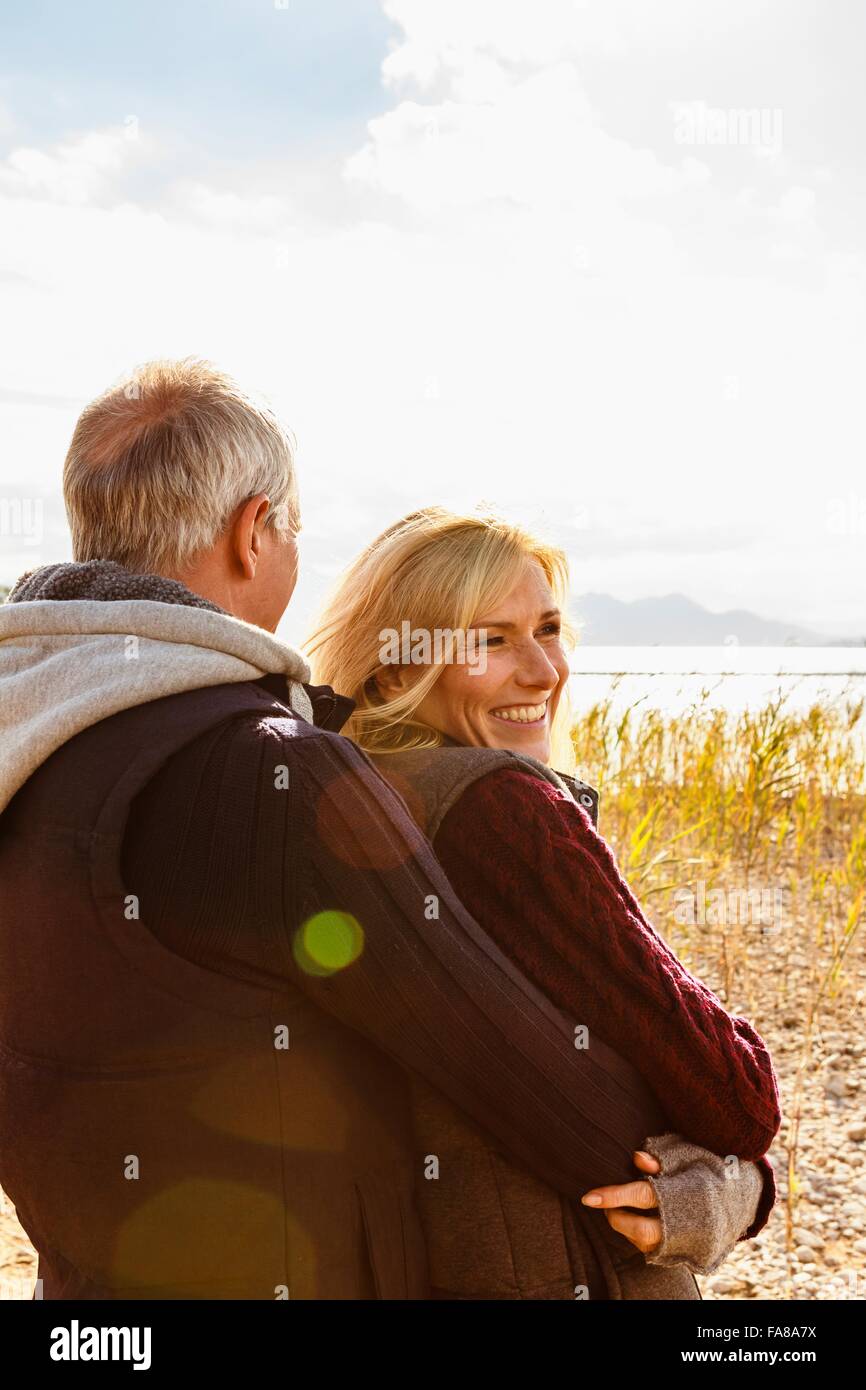 Mature couple, outdoors, hugging, smiling, rear view Stock Photo - Alamy