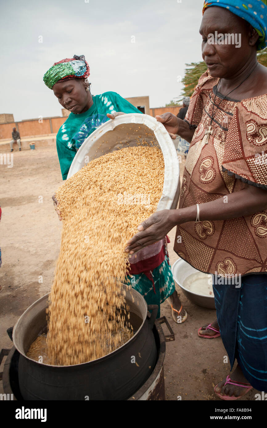 Rice is parboiled before being sold at a women's group processing ...