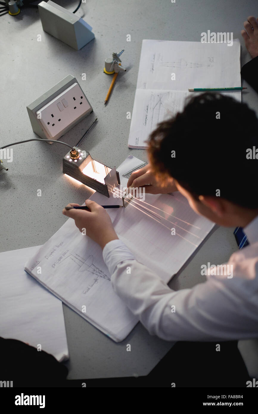 Student experimenting with lenses in a British science class Stock ...