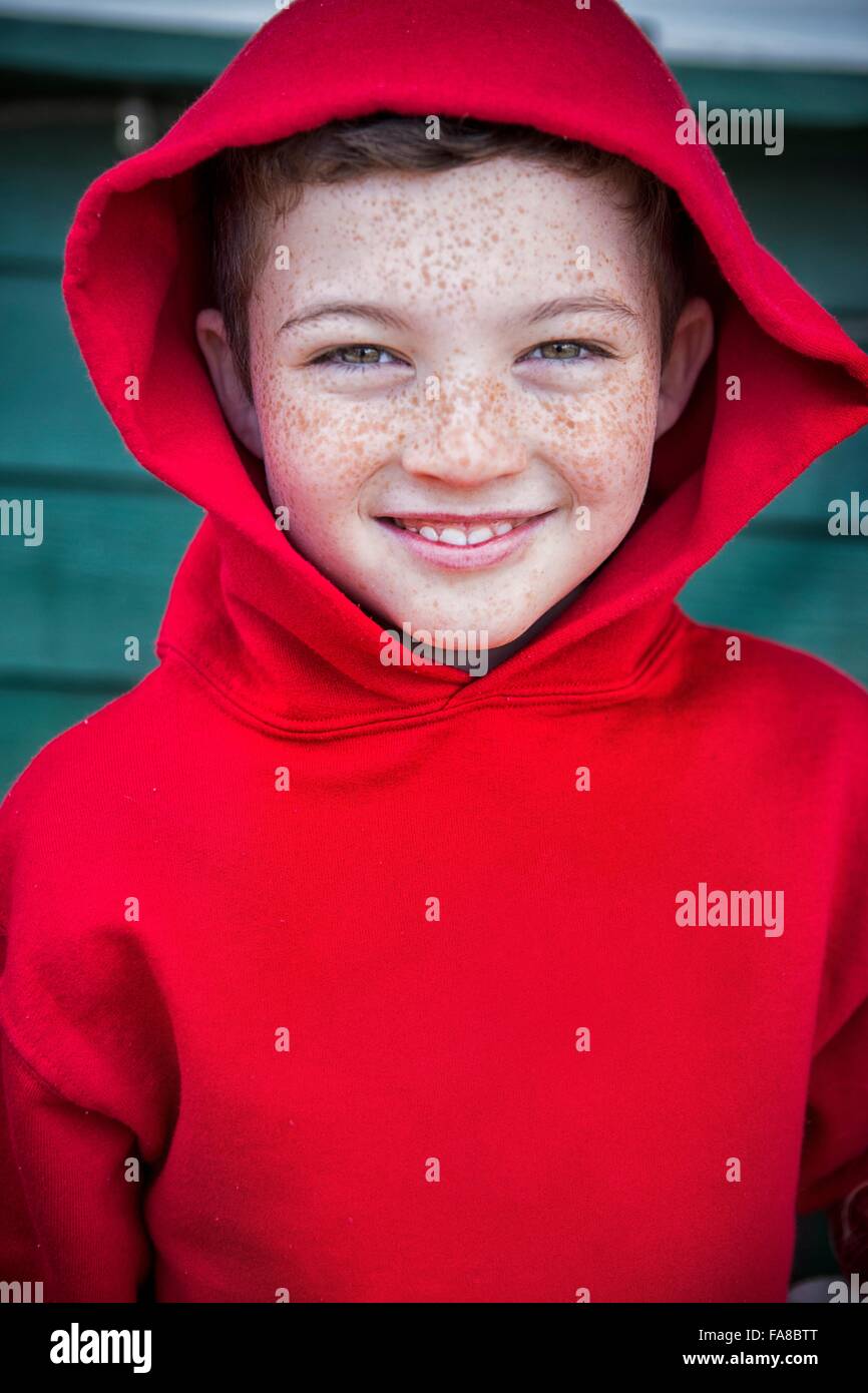 Portrait of happy boy with face freckles wearing red hoody Stock Photo ...