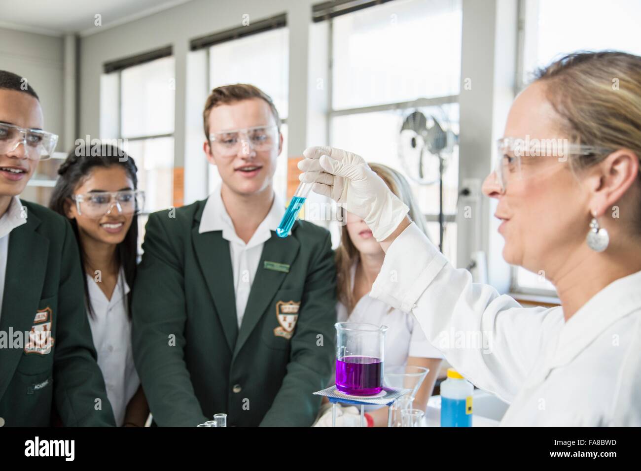 Teacher showing experiment to students in lab Stock Photo - Alamy