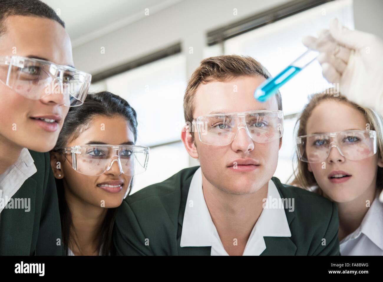 Students conducting experiment in lab Stock Photo - Alamy