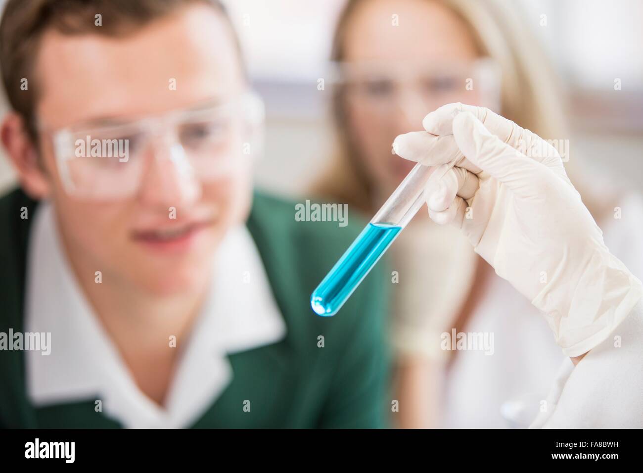 Students conducting experiment in lab Stock Photo - Alamy