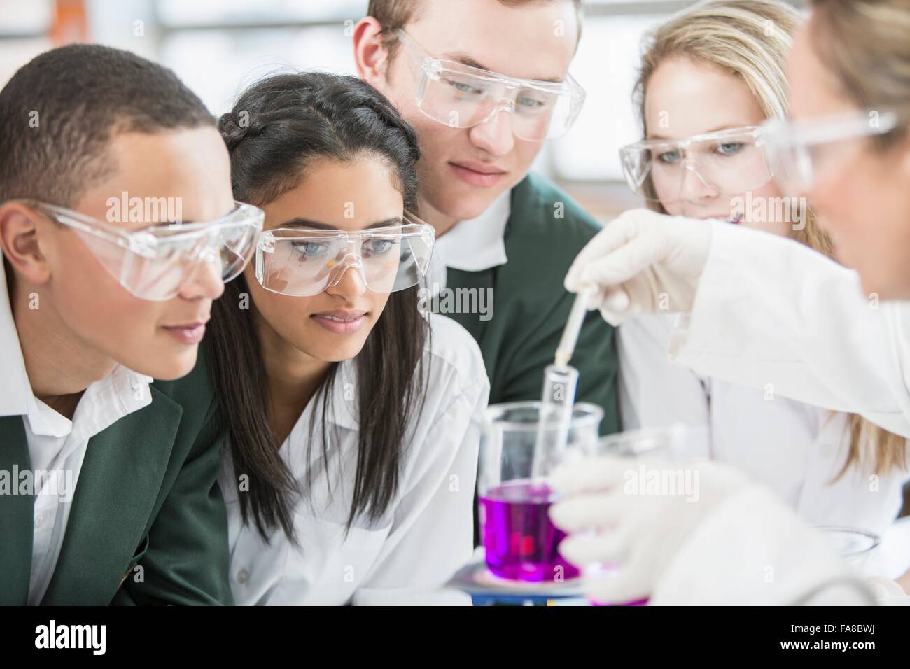Teacher showing experiment to students in lab Stock Photo - Alamy