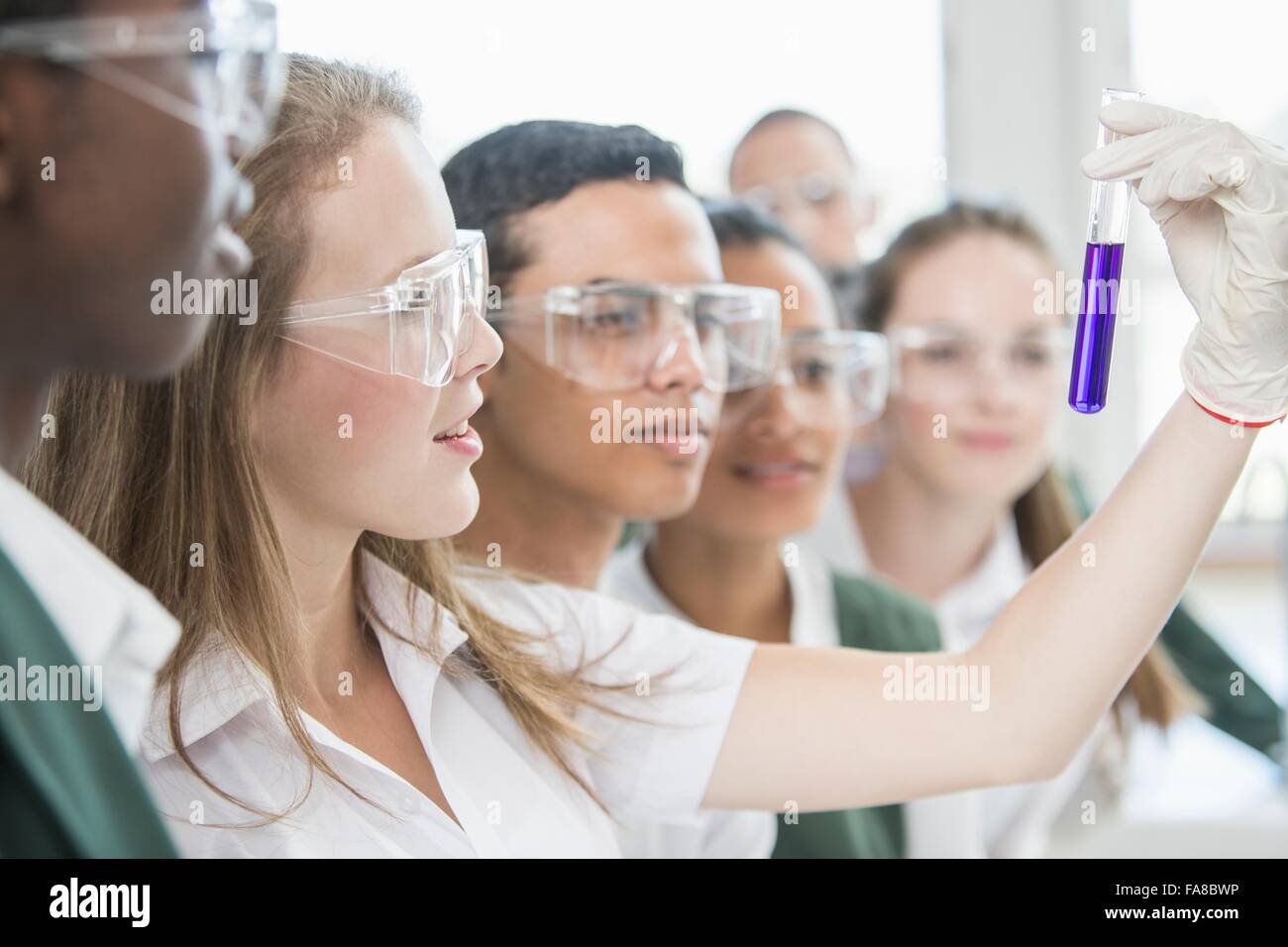 Students conducting experiment in lab Stock Photo - Alamy