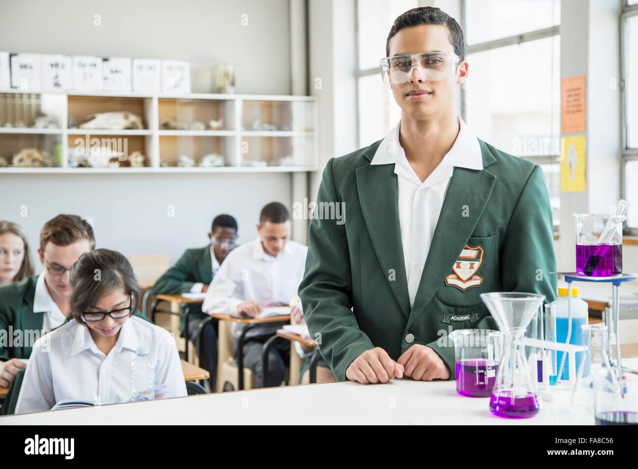 Student in lab, classmates in background Stock Photo - Alamy