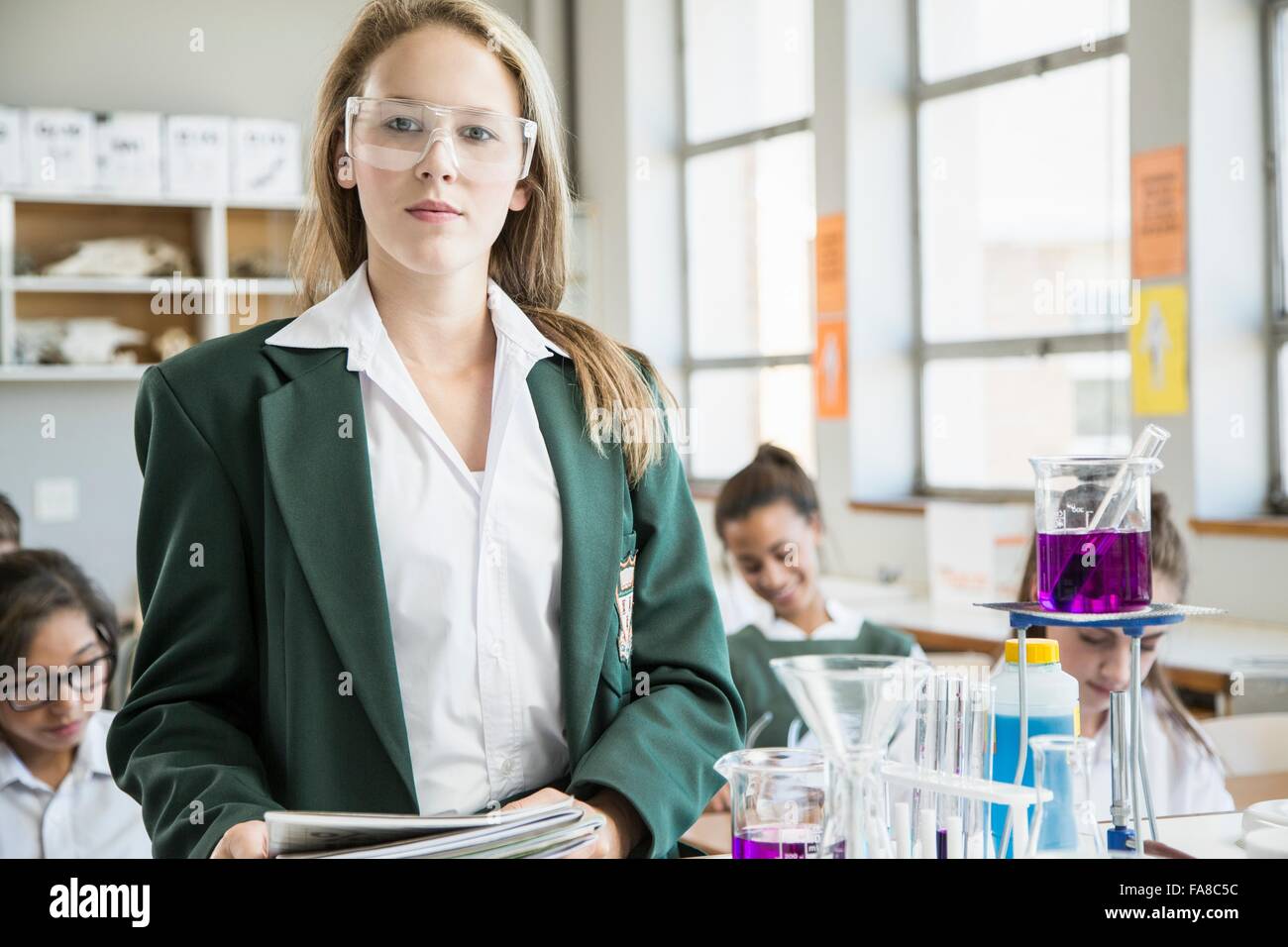 Student in lab, classmates in background Stock Photo - Alamy