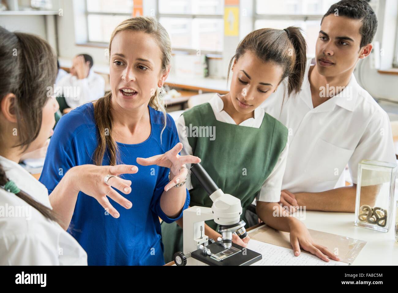Students listening to teacher in lab Stock Photo - Alamy