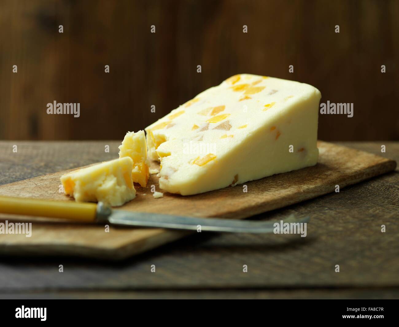 Mango and ginger stilton cheese on small wooden cheese board Stock ...