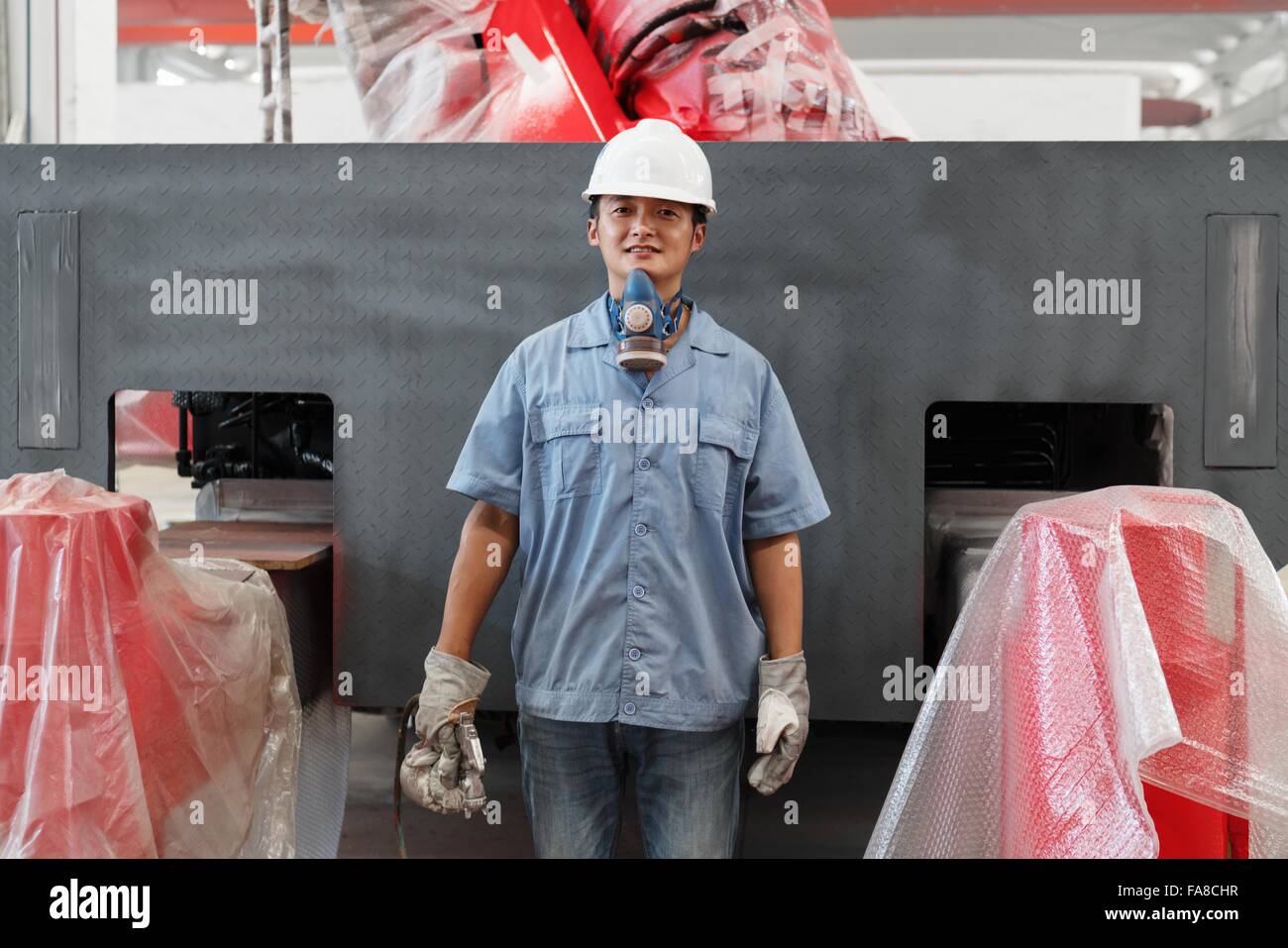 Portrait of male spray painting worker in crane factory, China Stock ...