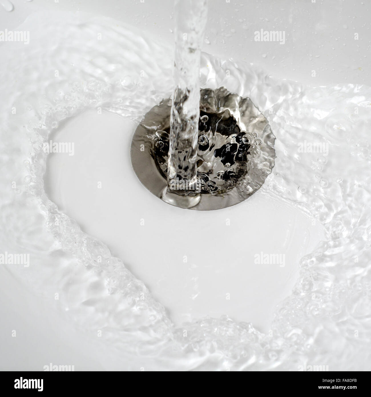 water flow into drain in bath,close up photo Stock Photo - Alamy