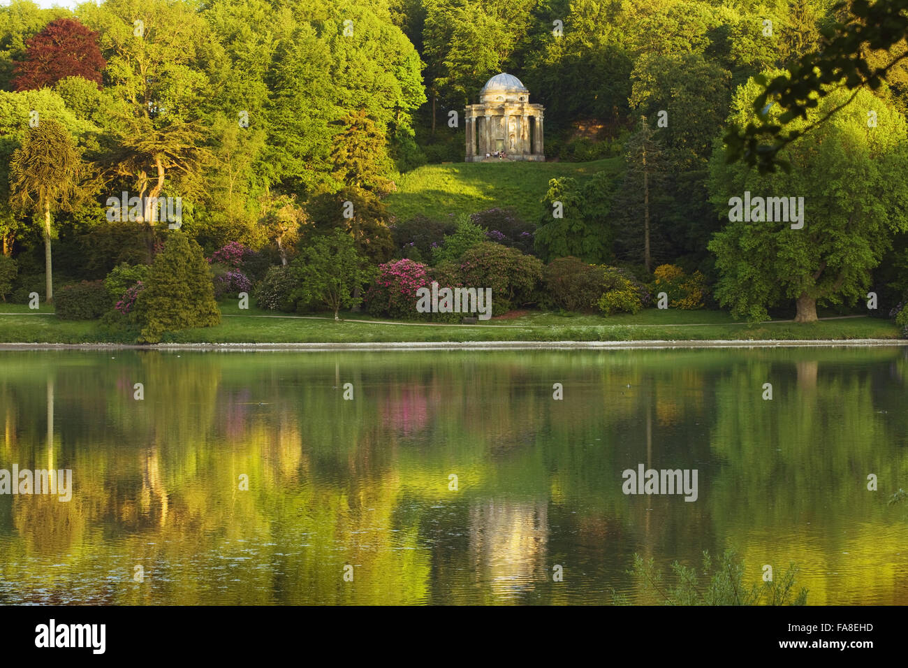 The Temple of Apollo reflected in the lake at Stourhead, Wiltshire, in ...