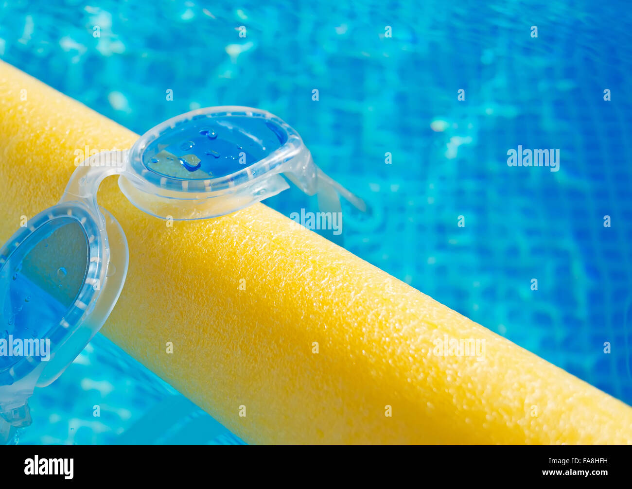 close up of pool goggles and yellow noodle Stock Photo - Alamy