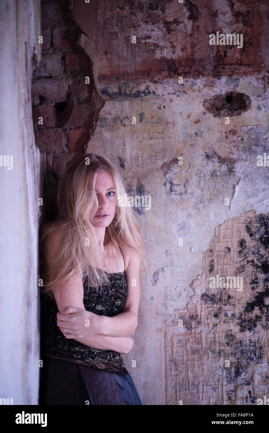 Woman cowering in the corner of a room hi-res stock photography and images - Alamy