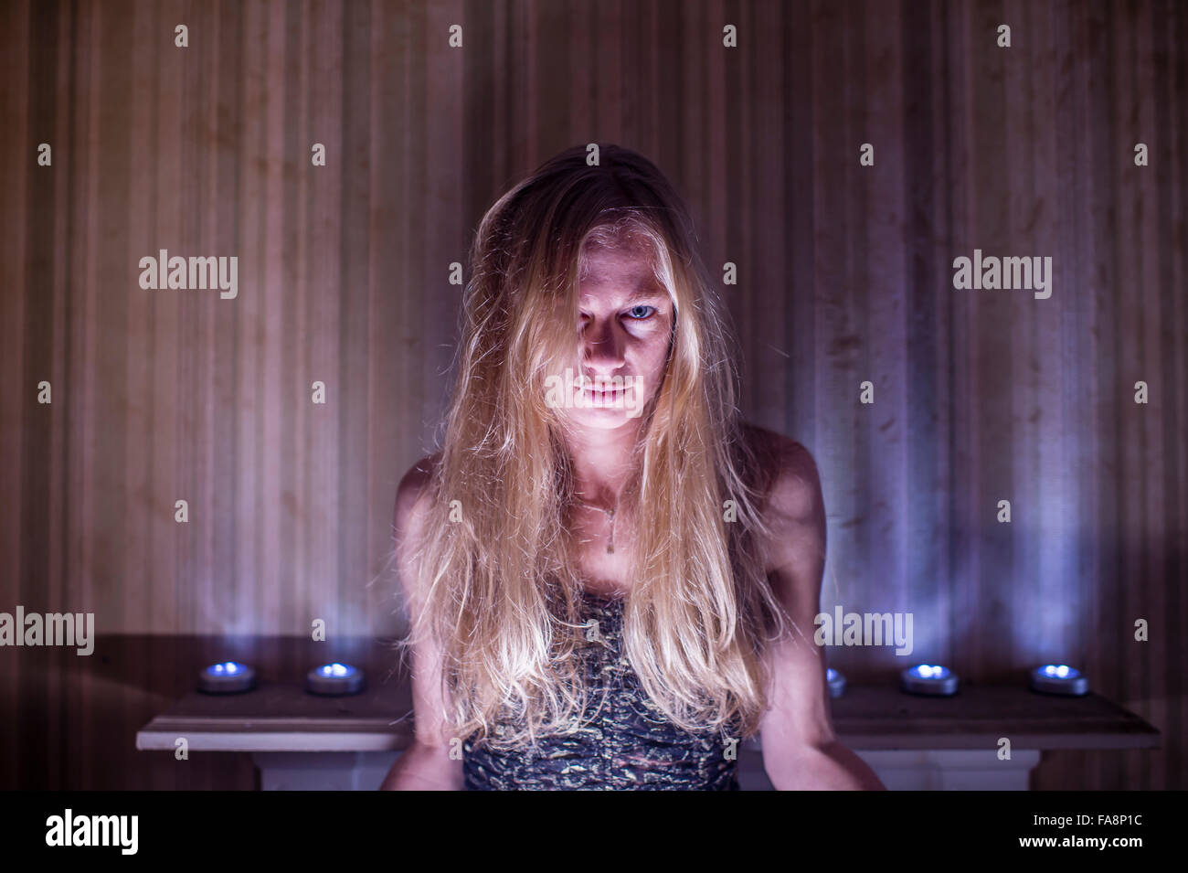 A young slim blonde haired wild eyed crazed deranged woman girl with ...