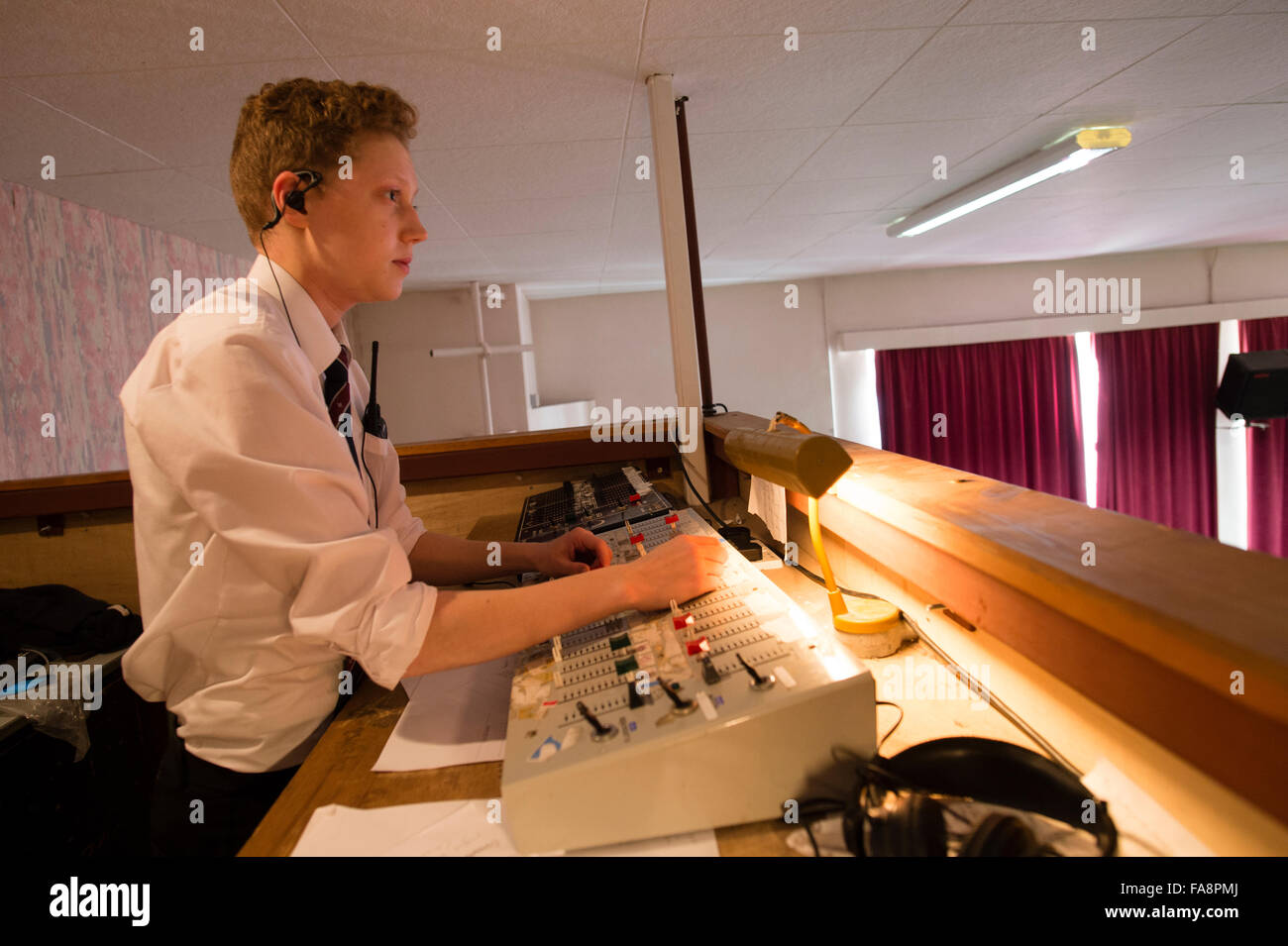 Secondary school teenage students pupil operating the lighting control ...
