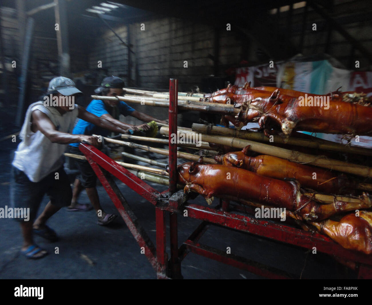 Quezon City, Philippines. 23rd Dec, 2015. Filipino workers carry ...