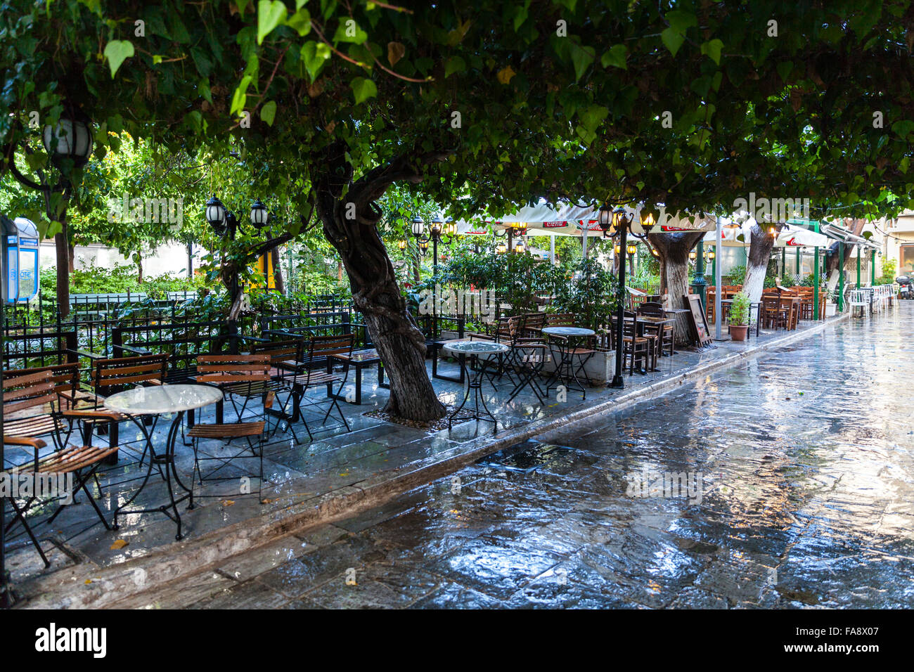 Empty outdoor restaurant seats following a rain shower, Filomousou ...