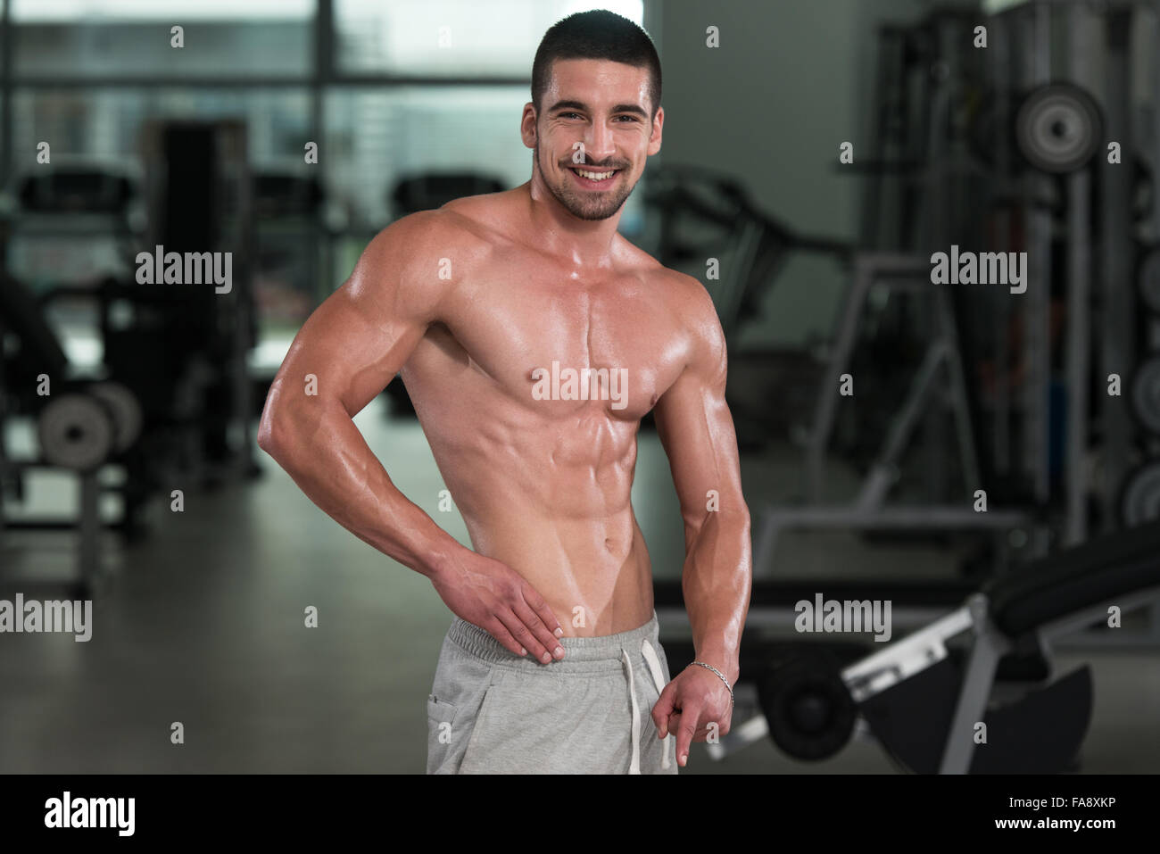Awesome Bodybuilder Showing His Muscles And Posing In Gym Stock Photo ...