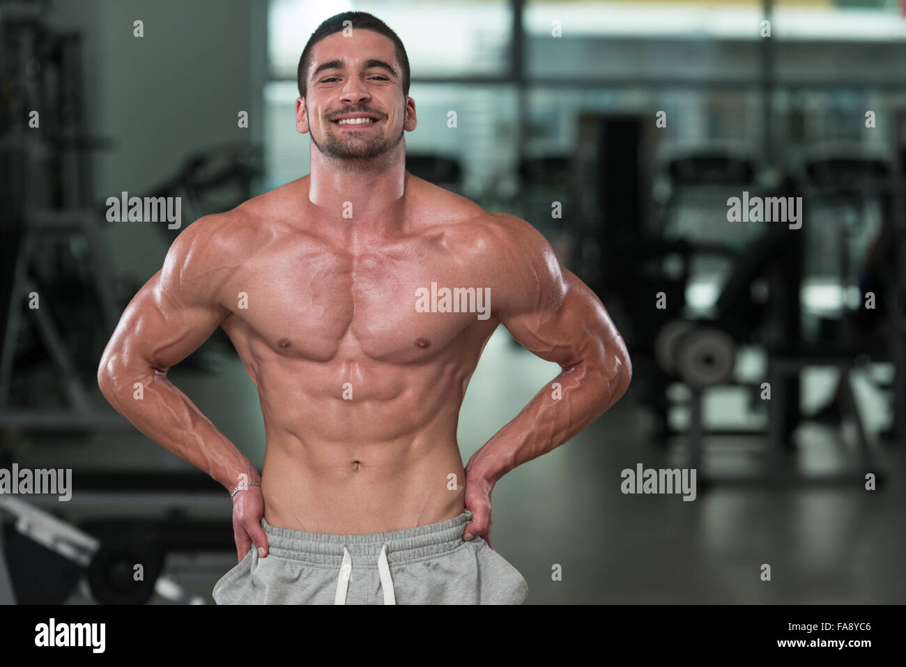 Awesome Bodybuilder Showing His Muscles And Posing In Gym Stock Photo ...