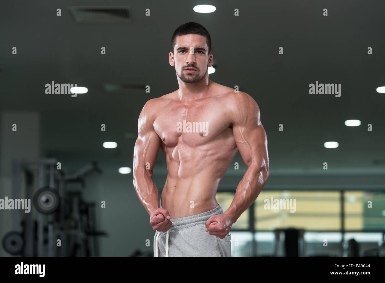 Awesome Bodybuilder Showing His Muscles And Posing In Gym Stock Photo ...
