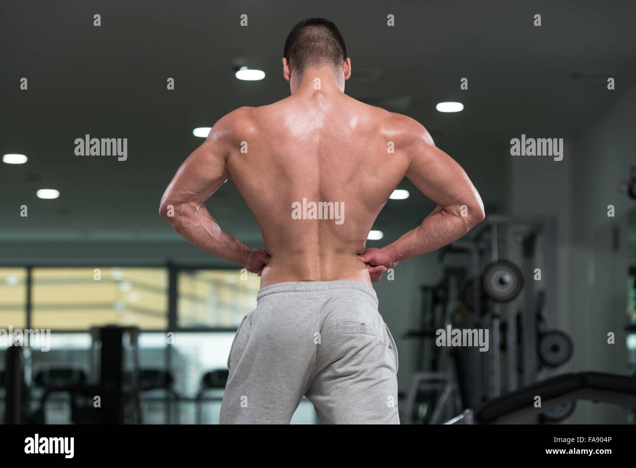 Awesome Bodybuilder Showing His Muscles And Posing In Gym Stock Photo ...