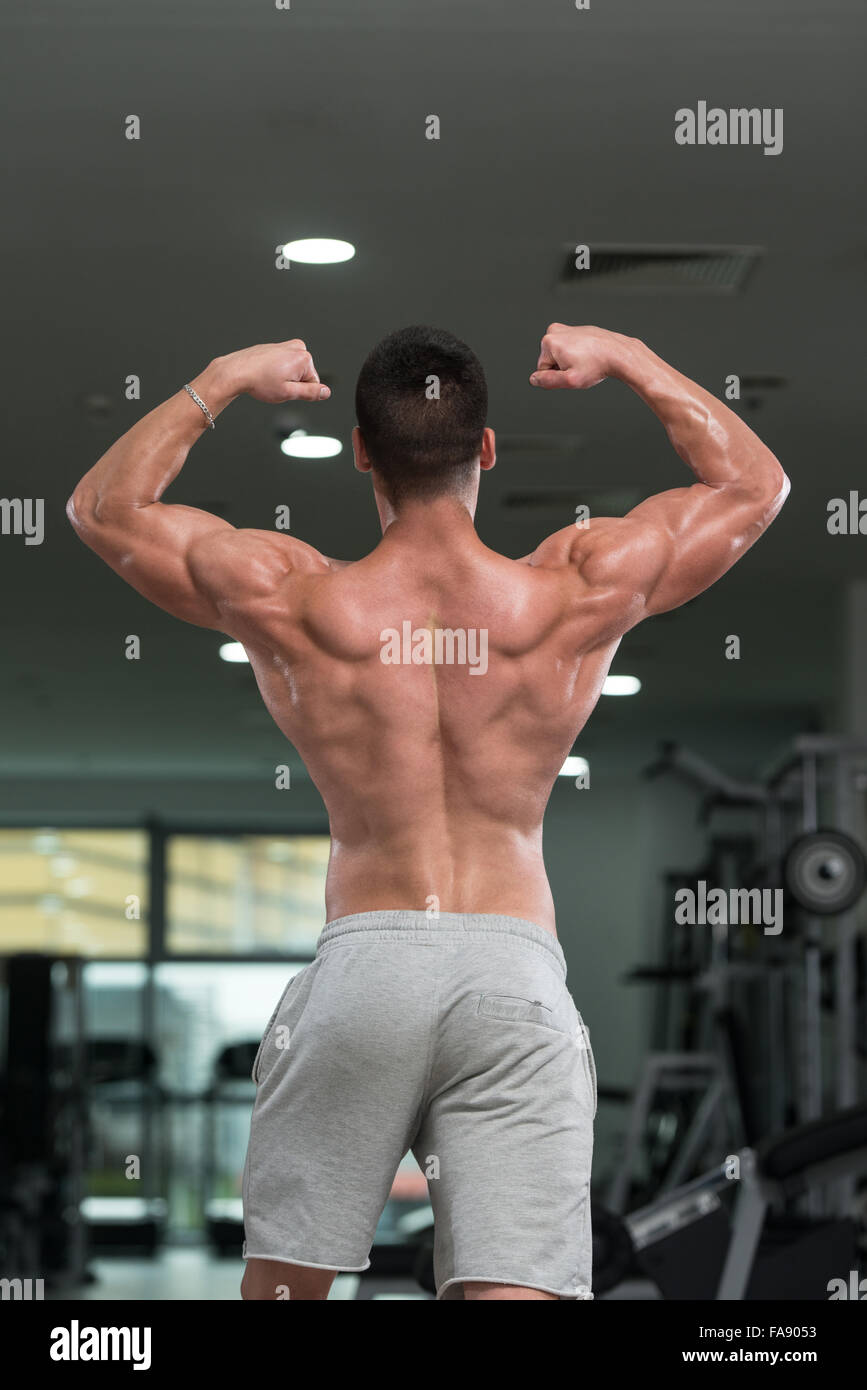 Awesome Bodybuilder Showing His Muscles And Posing In Gym Stock Photo ...