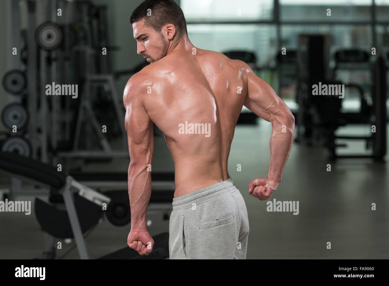 Awesome Bodybuilder Showing His Muscles And Posing In Gym Stock Photo ...