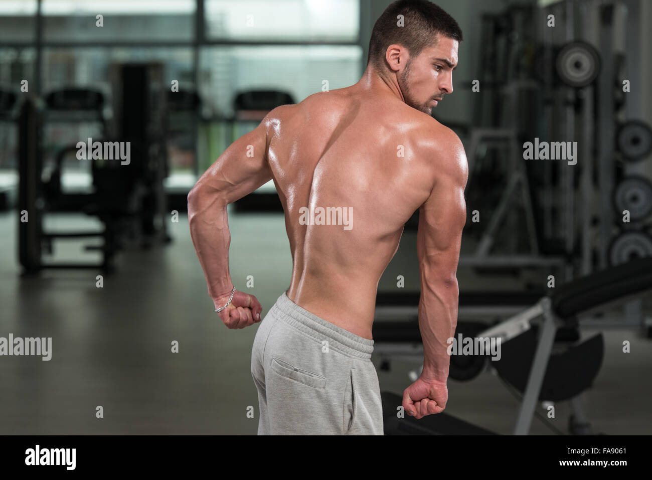 Awesome Bodybuilder Showing His Muscles And Posing In Gym Stock Photo ...
