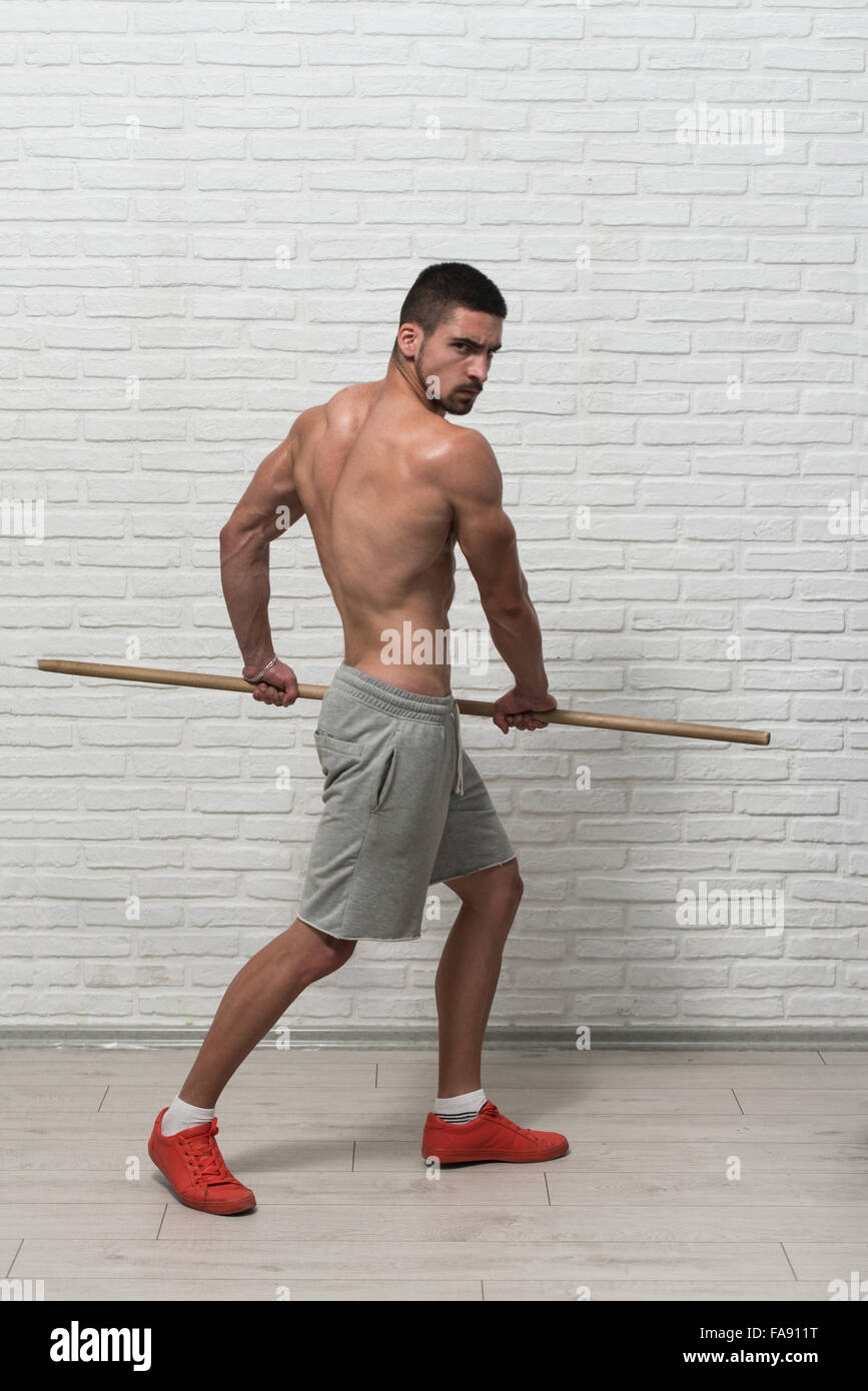 Athlete Muscular Bodybuilder Emotional Posing At The Wall With Stick ...