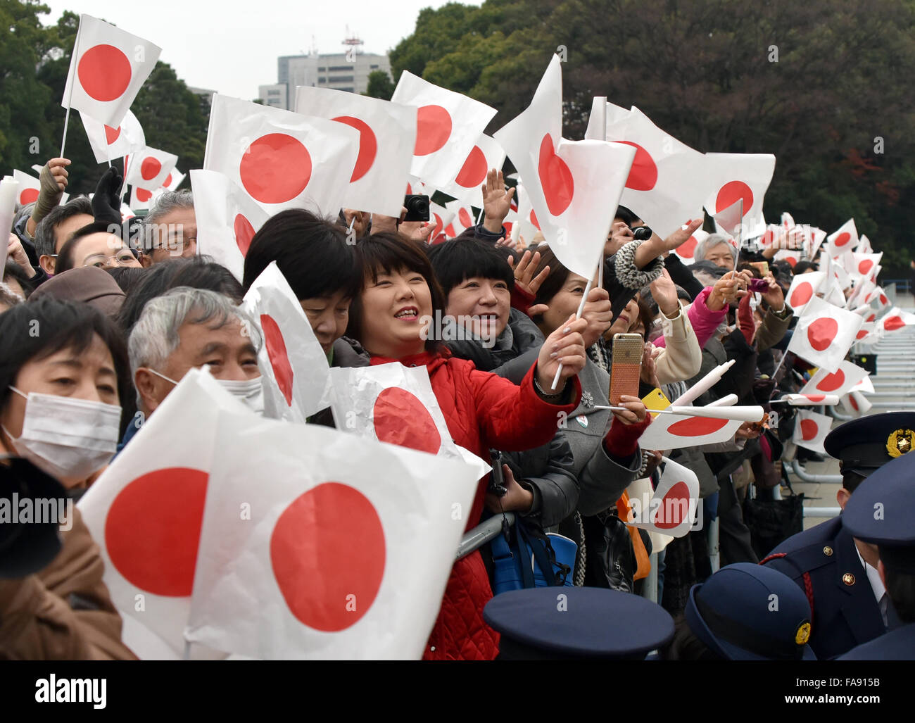 Tokyo, Japan. 23rd Dec, 2015. Thousands of well-wishers wave Japanese ...