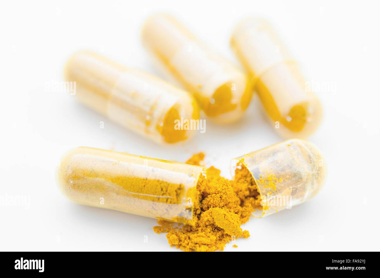Turmeric herbal powder in capsule on white background Stock Photo - Alamy