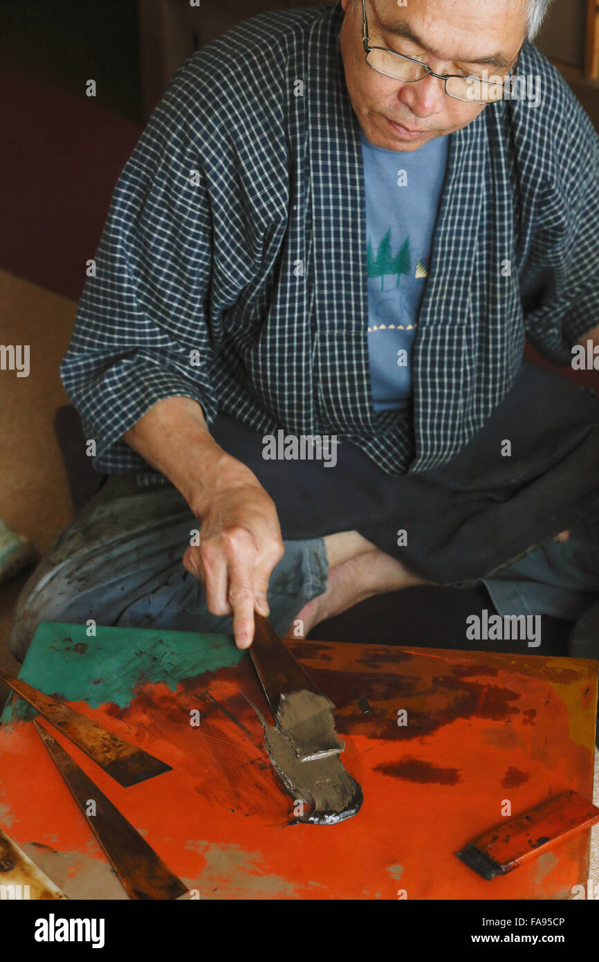 Japanese lacquer artisan working in the studio Stock Photo - Alamy