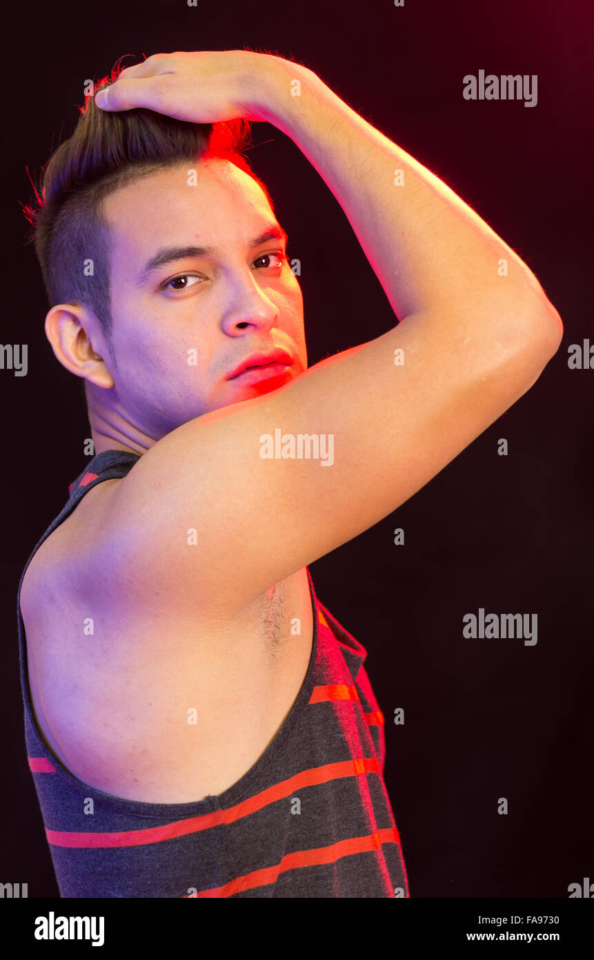Hispanic male wearing red black striped singlet posing with serious ...