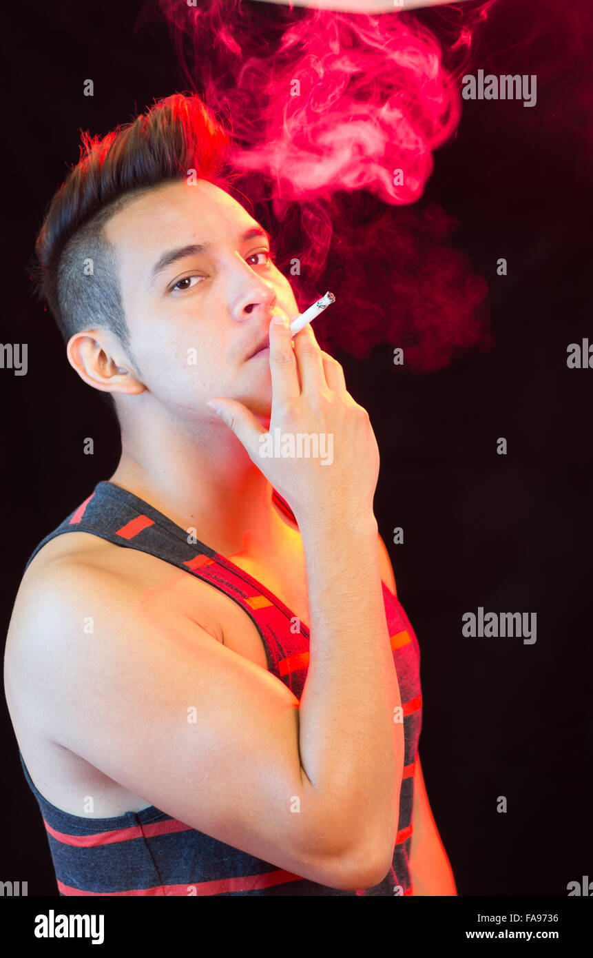 Hispanic male wearing red black striped singlet posing with serious ...