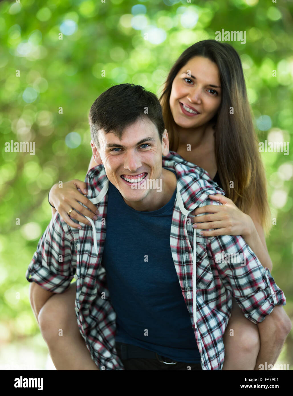 Young guy and his girlfriend in park at sunny day Stock Photo - Alamy