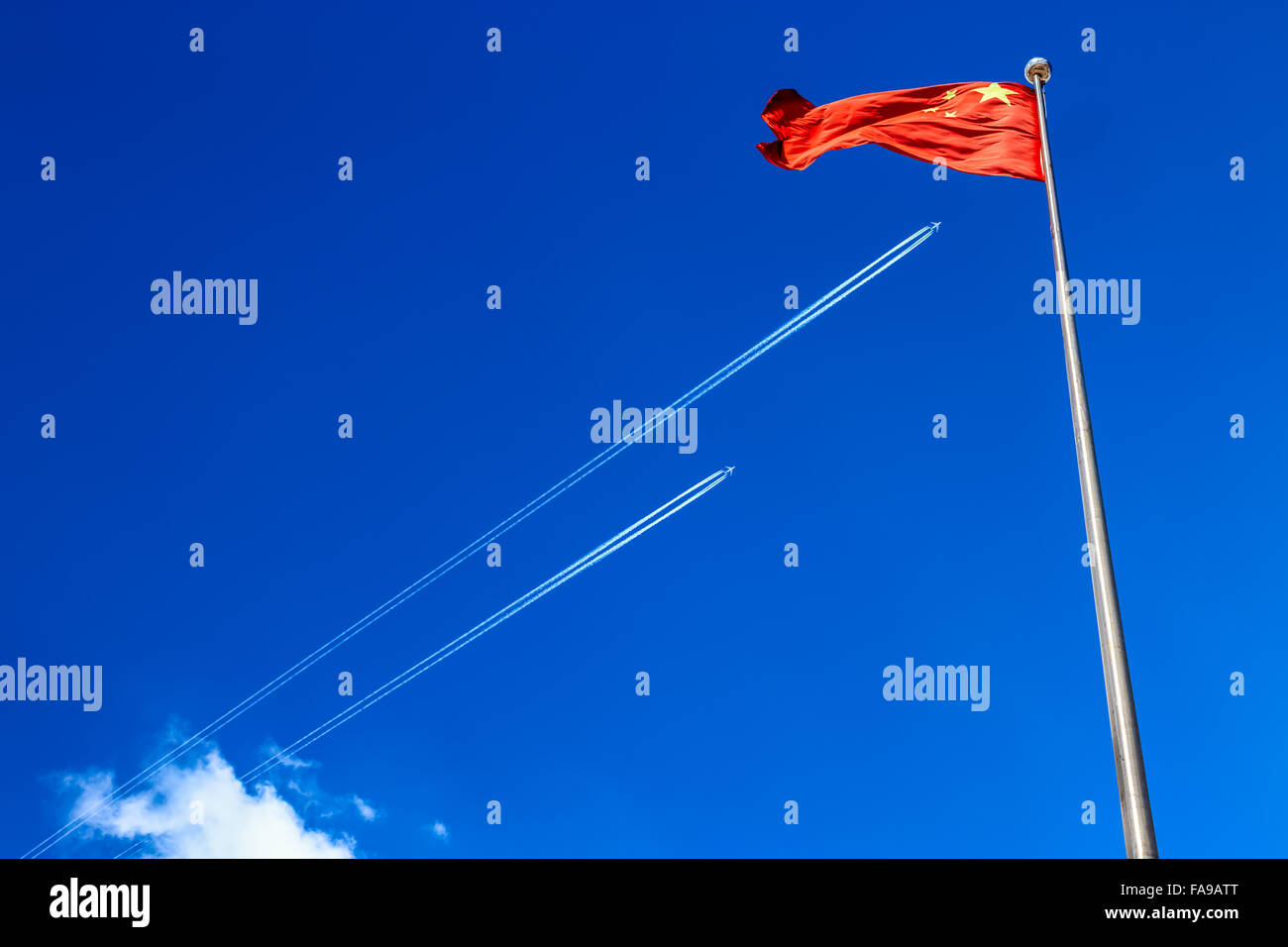 The national flag of China. A long trail of jet plane on blue sky Stock ...