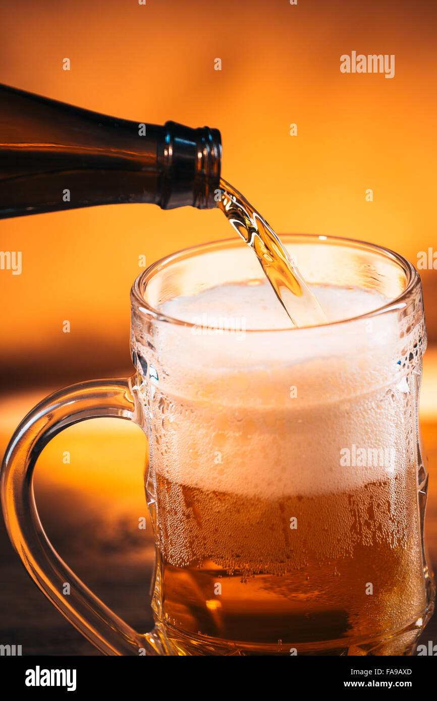 bright beer is poured into a glass mug Stock Photo - Alamy