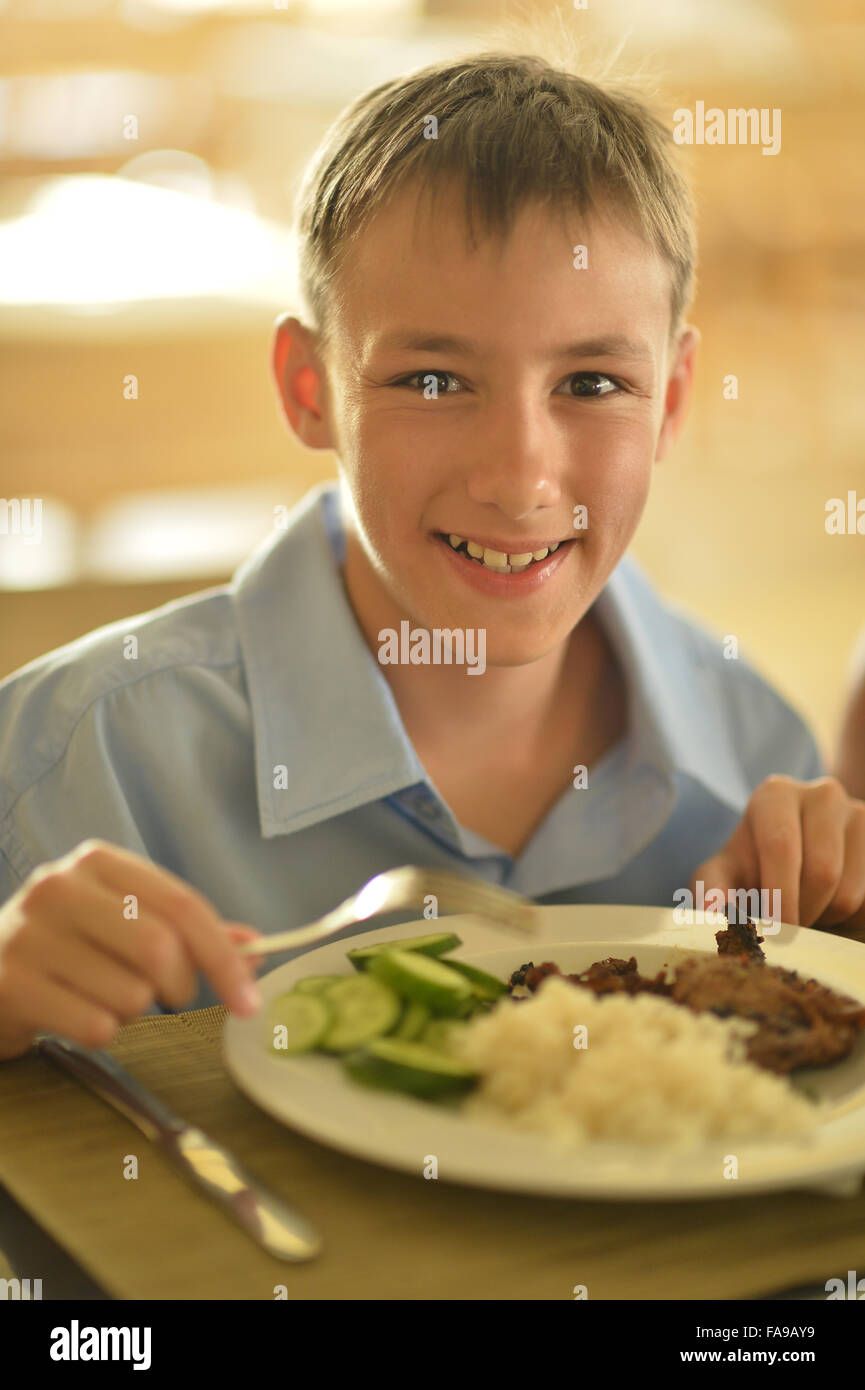 Happy boy at breakfast Stock Photo - Alamy