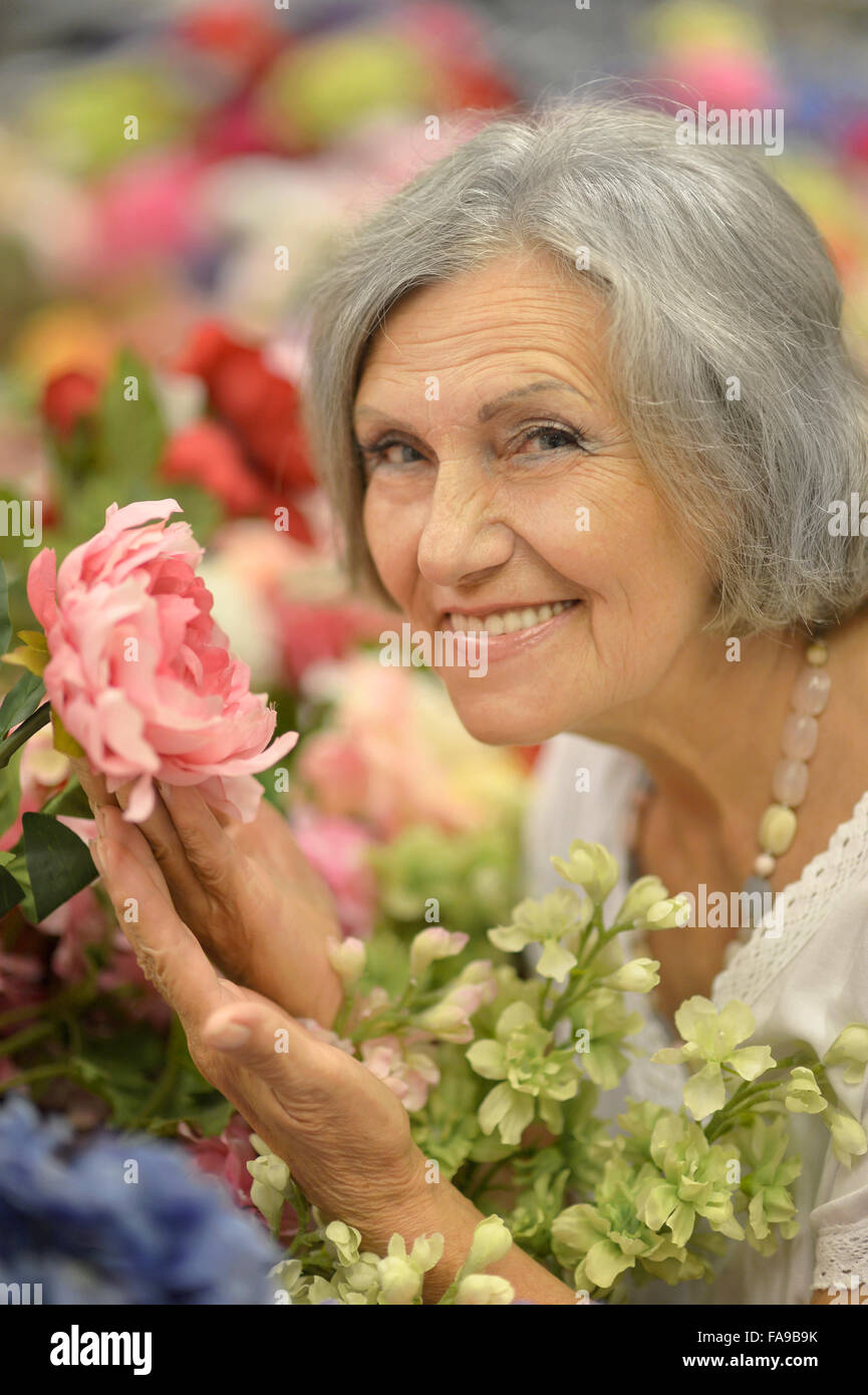 Older woman with flowers Stock Photo - Alamy