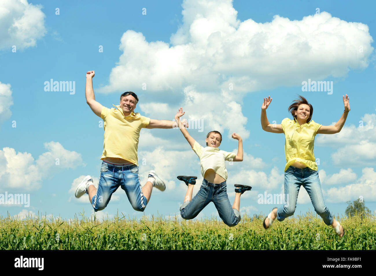 Happy family jumping on sky background Stock Photo - Alamy