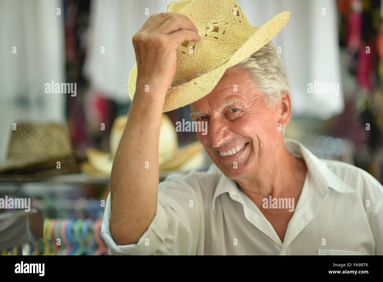 Senior man at shop hats Stock Photo - Alamy
