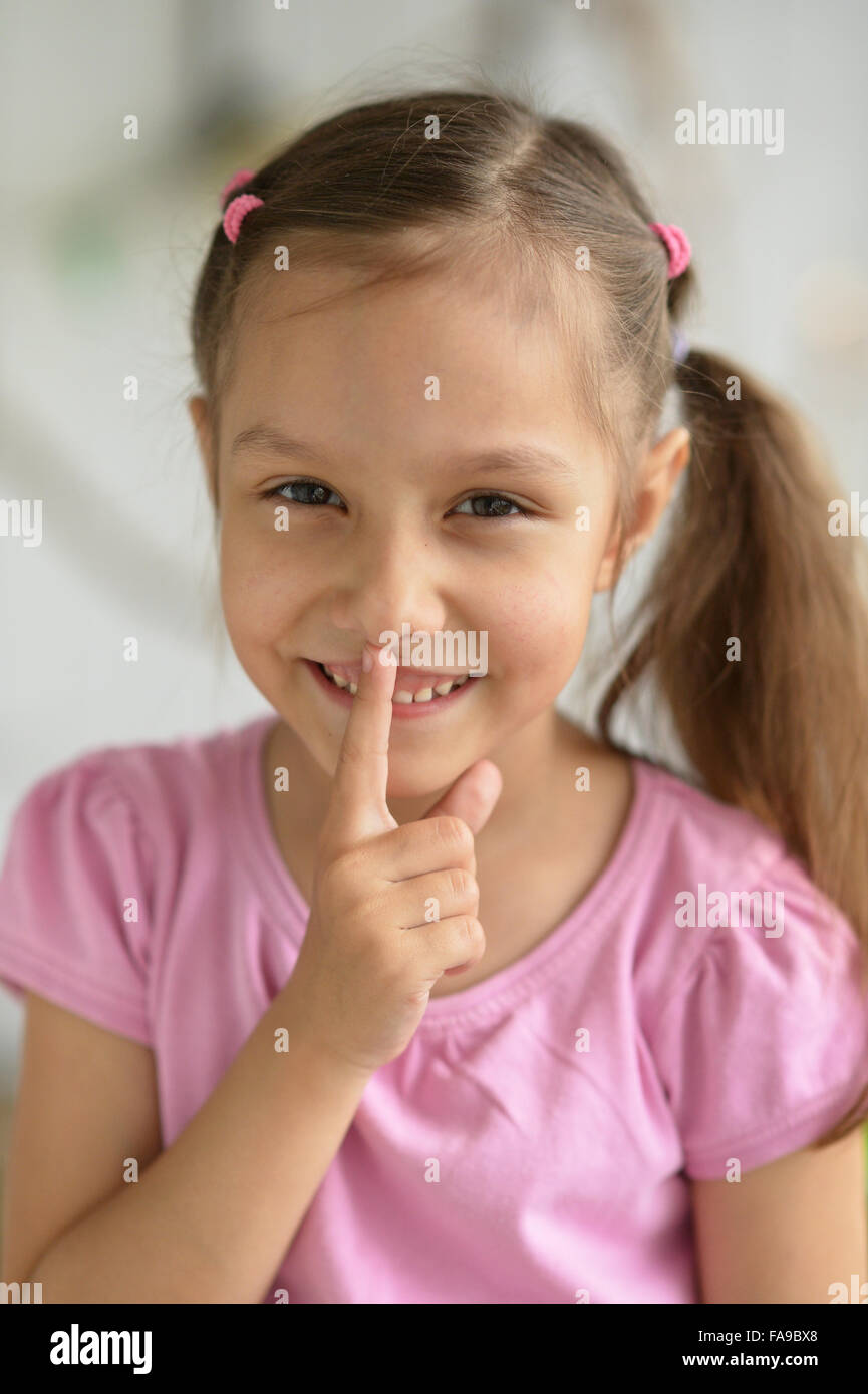 Little girl showing hush sign Stock Photo - Alamy